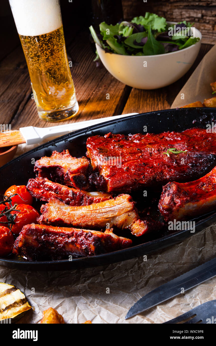 Grilled ribs in spicy marinade with salad and vegetables Stock Photo ...