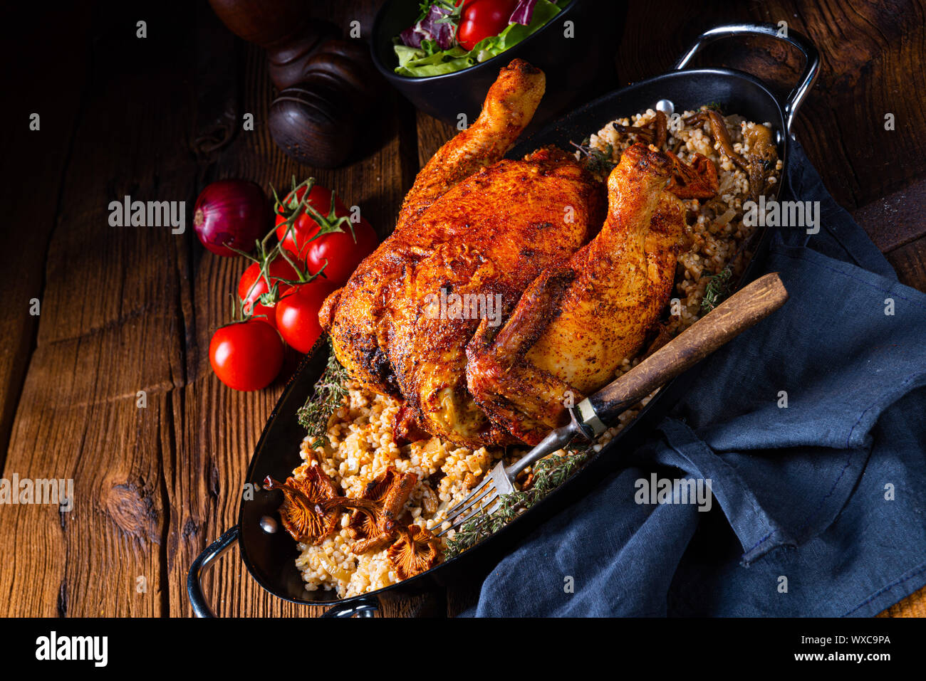 Grilled spicy chicken with barley groats and mushrooms Stock Photo - Alamy