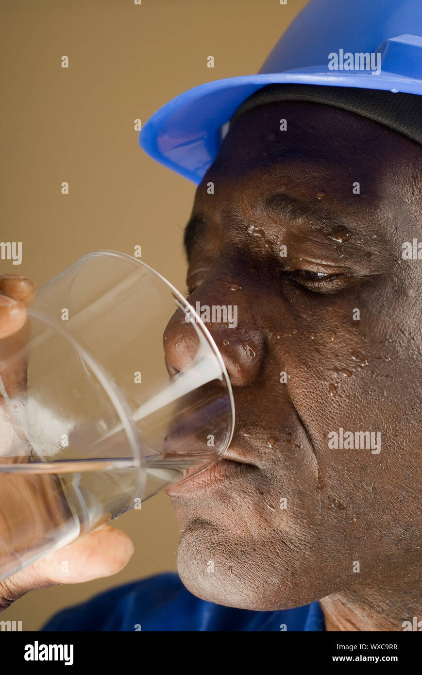 Tired Construction Worker Drinking Water Stock Photo - Alamy