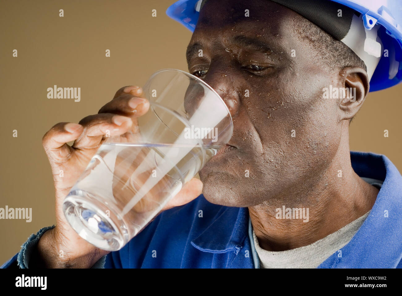 Tired Construction Worker Drinking Water Stock Photo - Alamy
