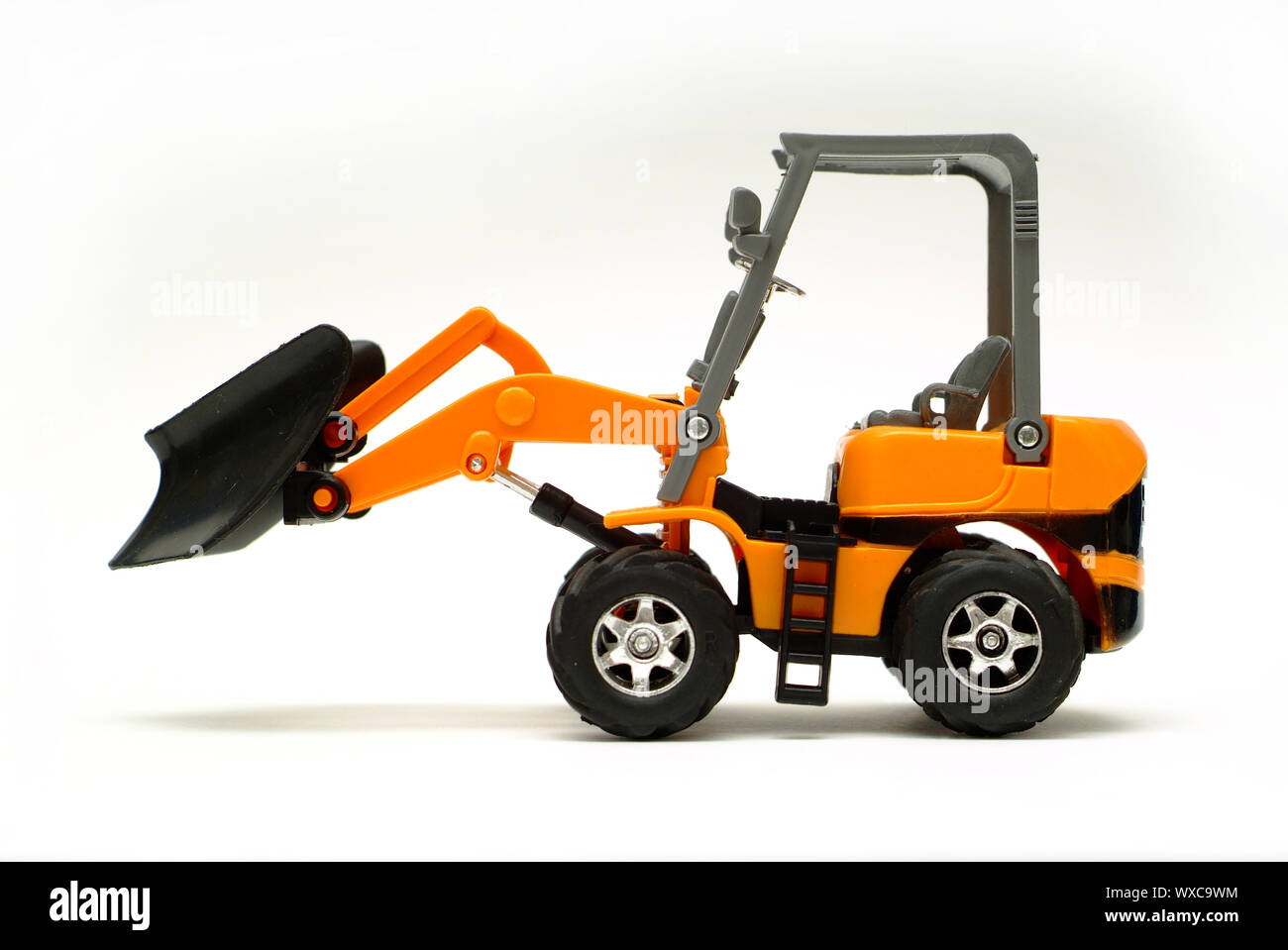 Small model bulldozer on white Stock Photo - Alamy