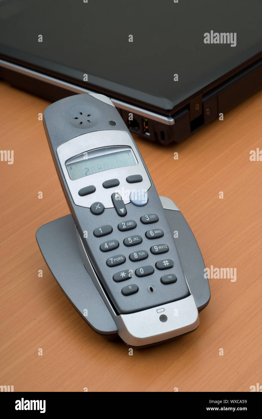 Mobile office telephone and laptop on desk Stock Photo - Alamy