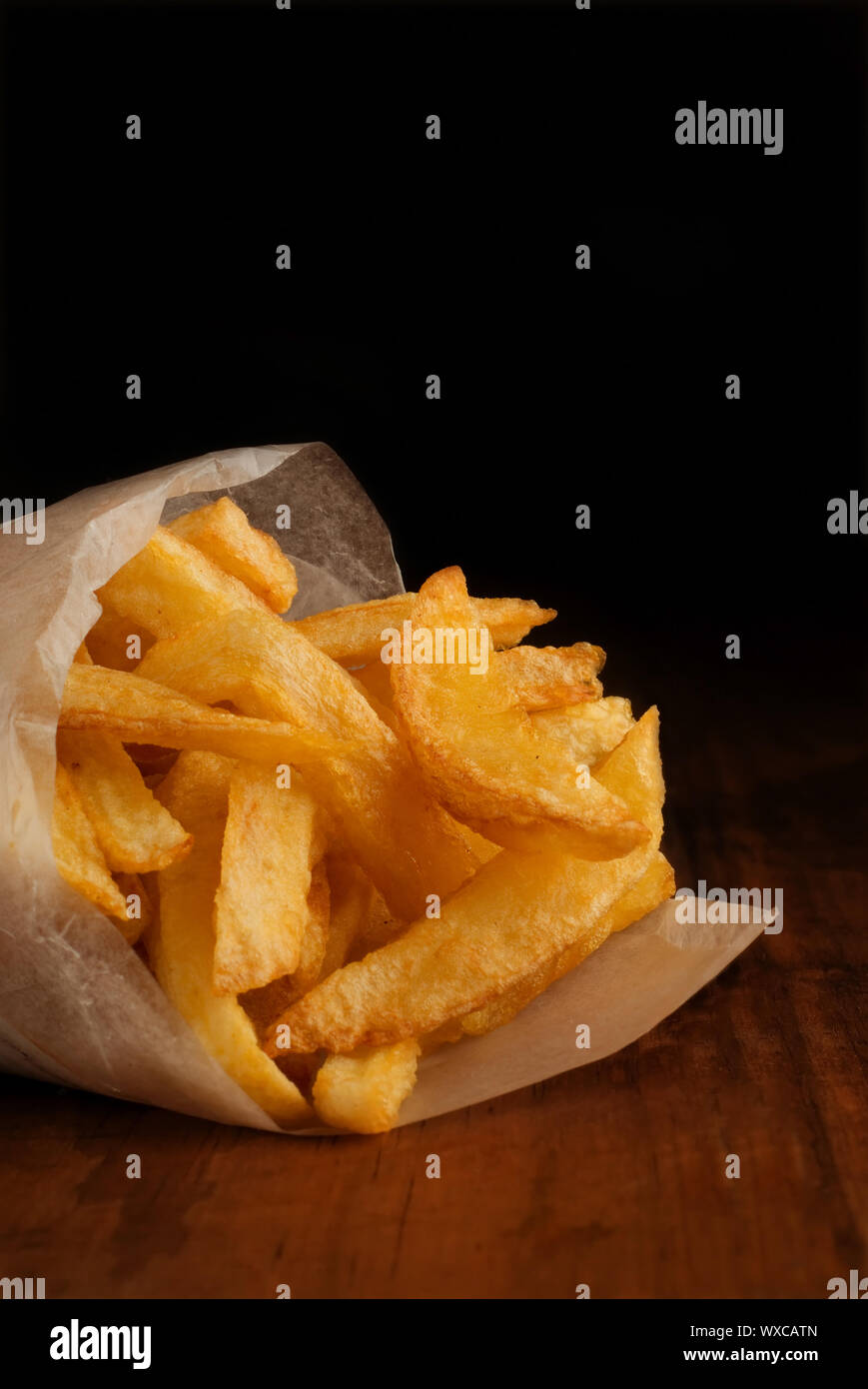 French fries in rolled newspaper packet or packaging Stock Photo - Alamy