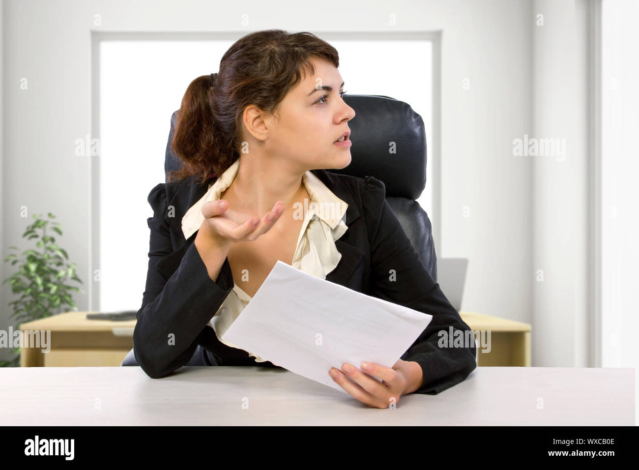 Young Caucasian female intern looking tired or stressed out in an ...