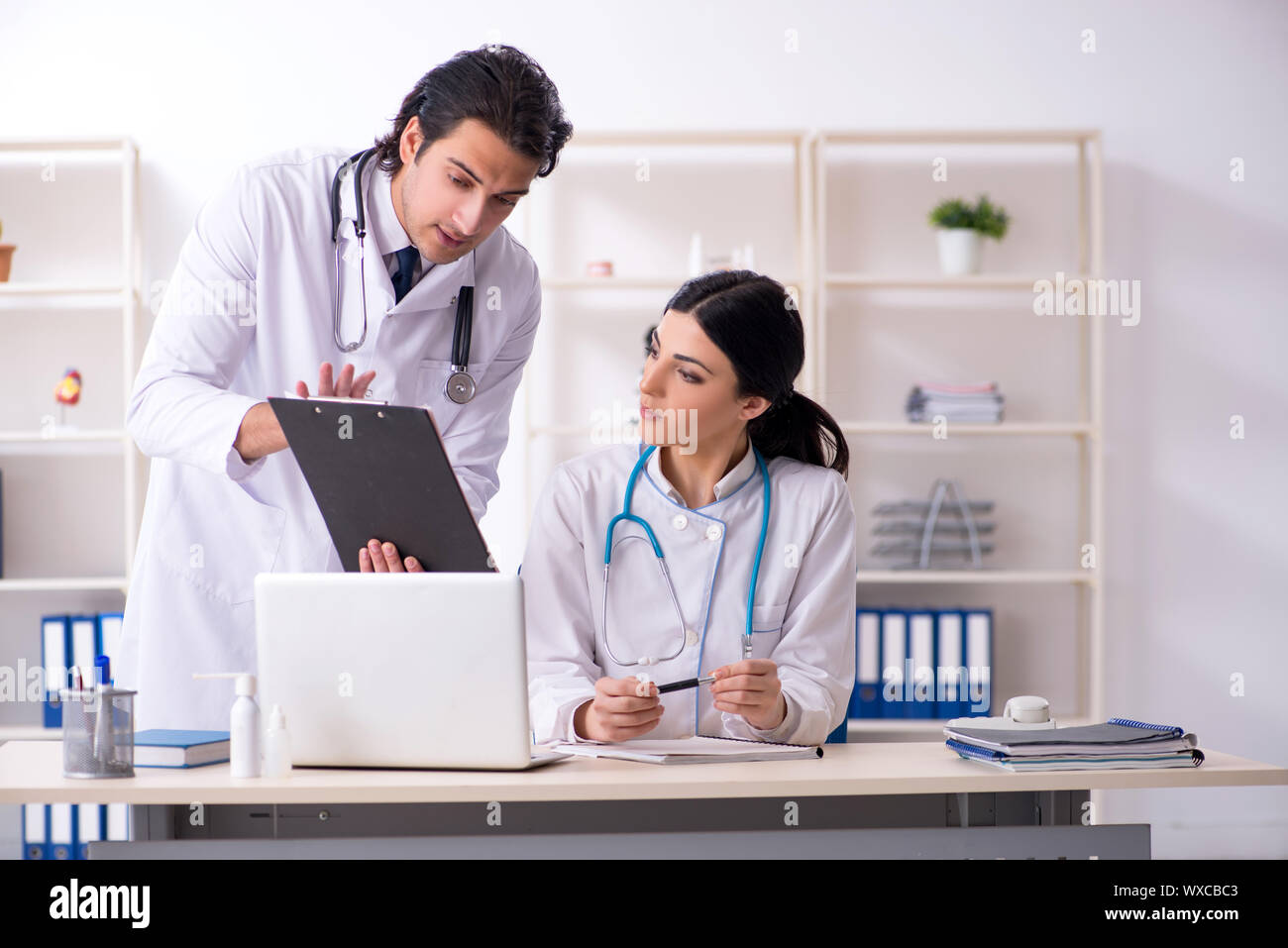 Two young doctors working in the clinic Stock Photo - Alamy