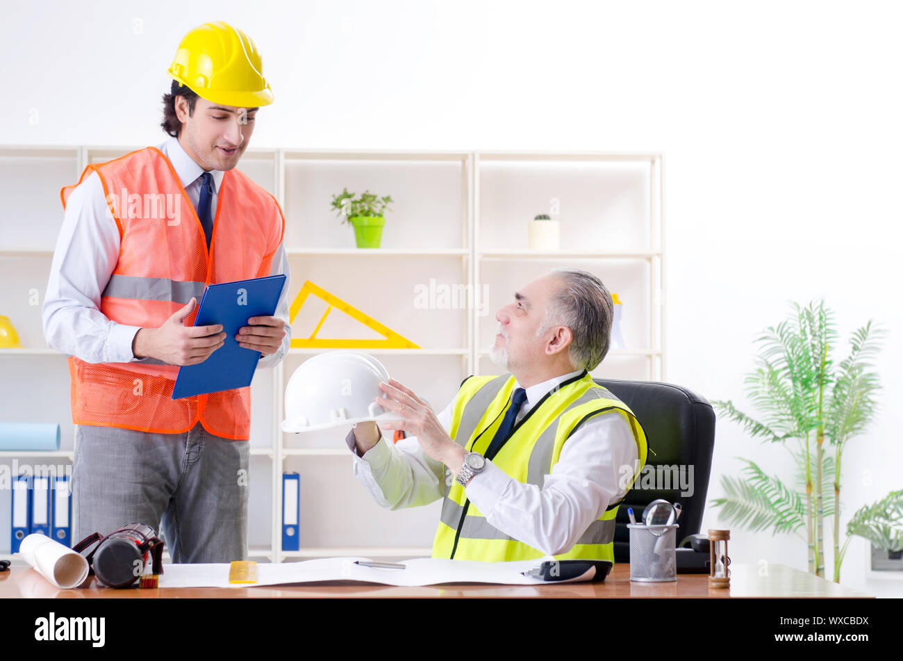 Two engineers colleagues working under project Stock Photo - Alamy