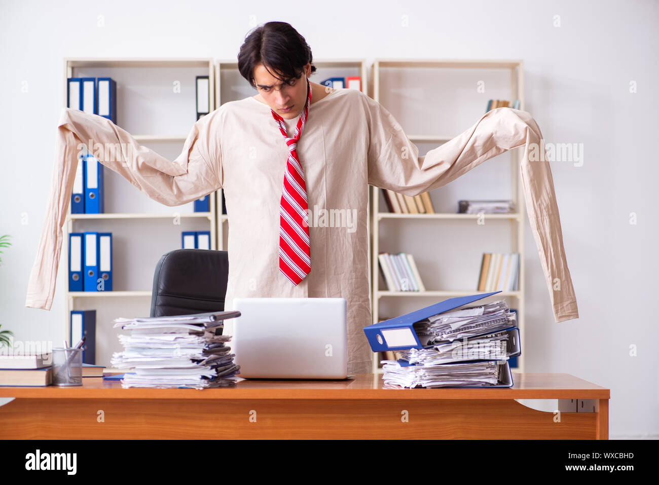 Crazy young man in straitjacket at the office Stock Photo - Alamy