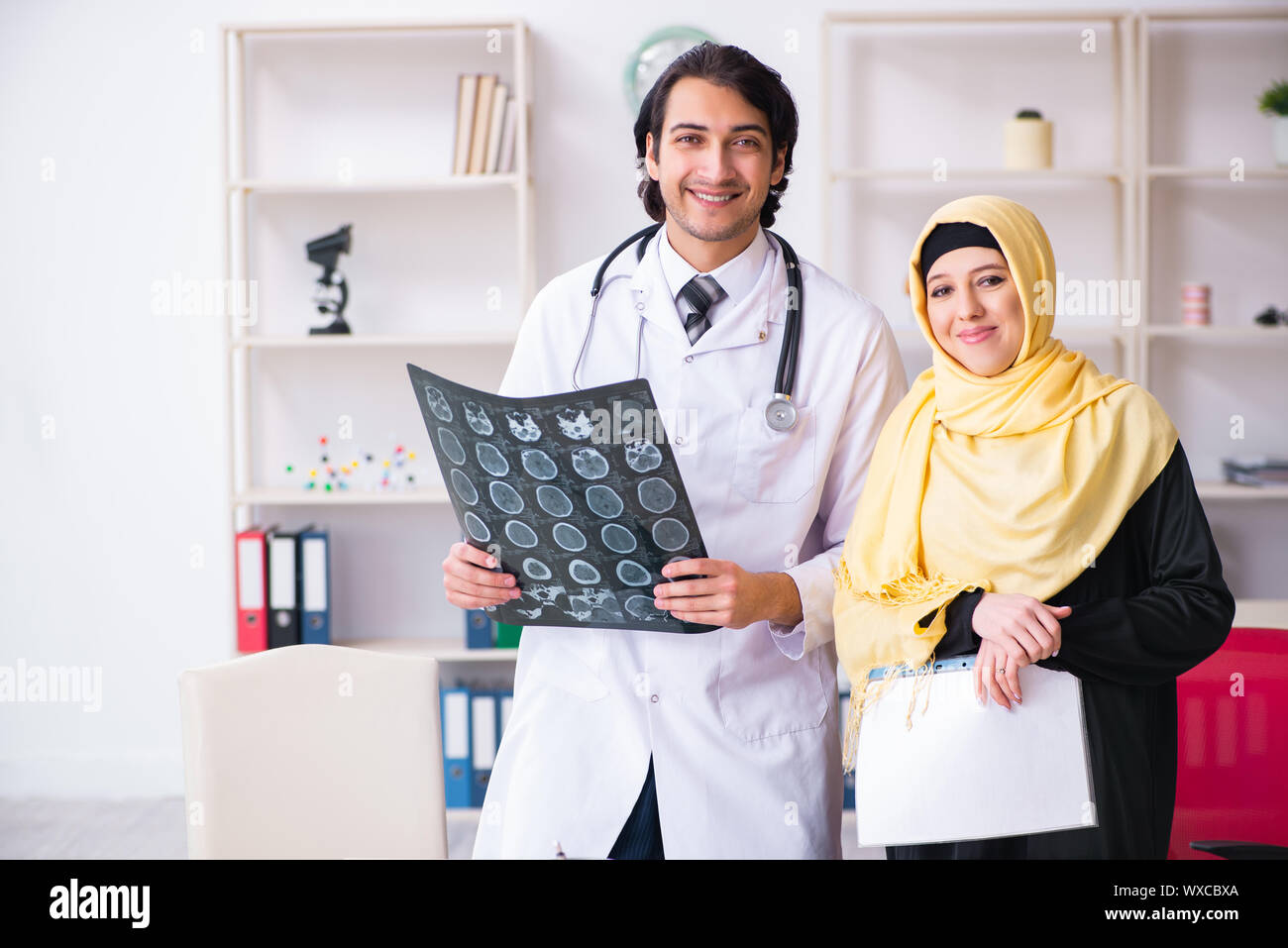 Female arab patient visiting male doctor Stock Photo - Alamy