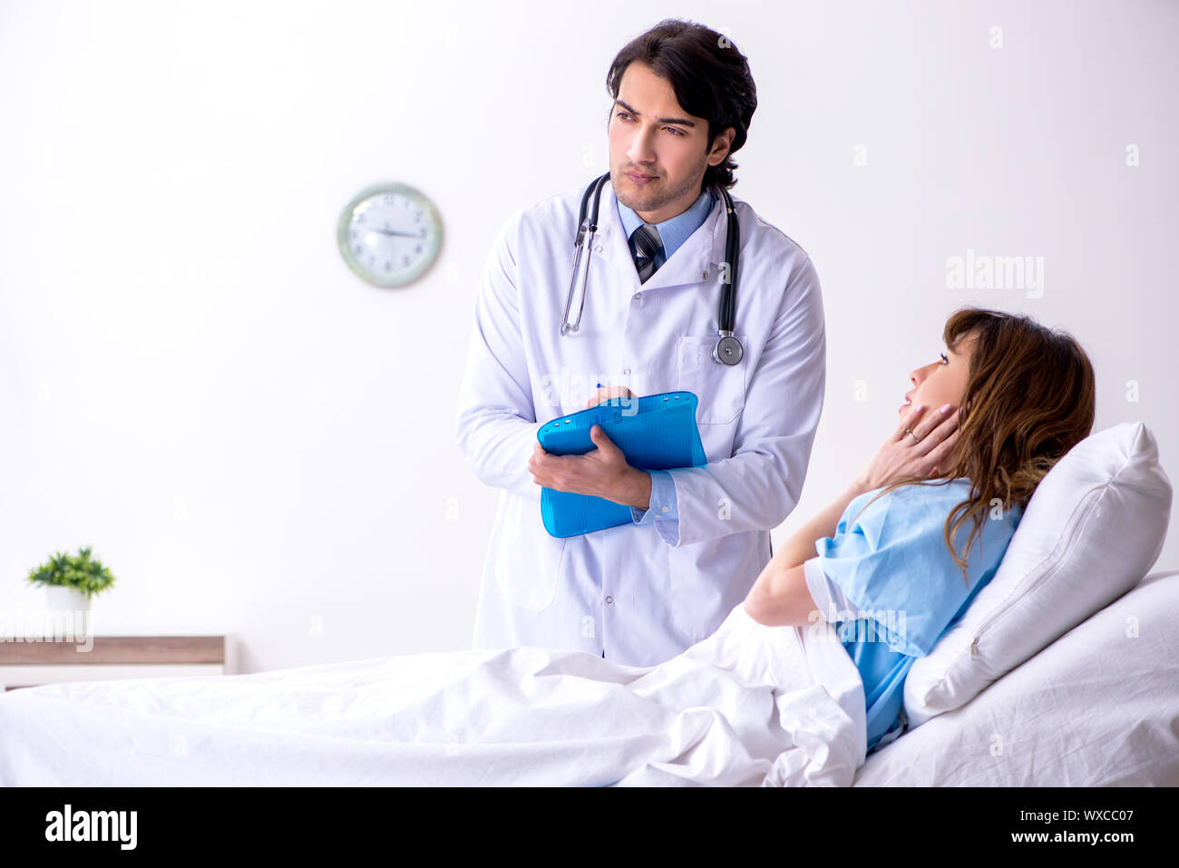 Male doctor visiting female patient in ward Stock Photo - Alamy