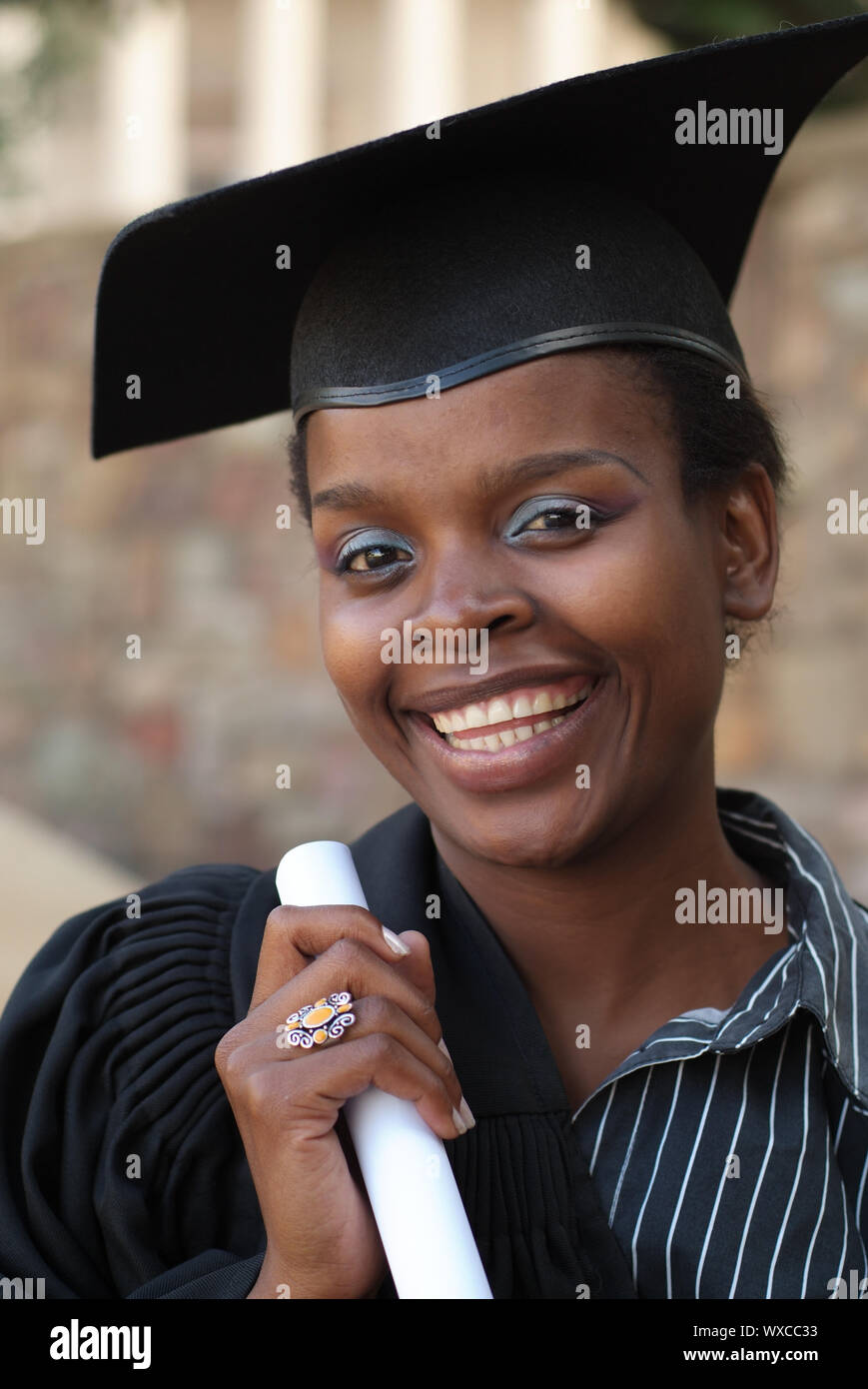 African American College Student Graduating with mortarboard and degree ...