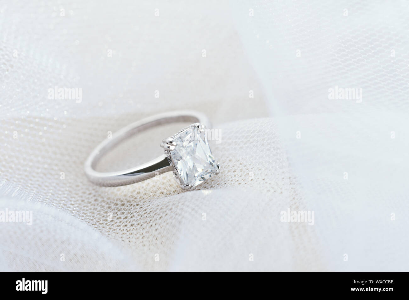 Engagement ring on white veil Stock Photo - Alamy