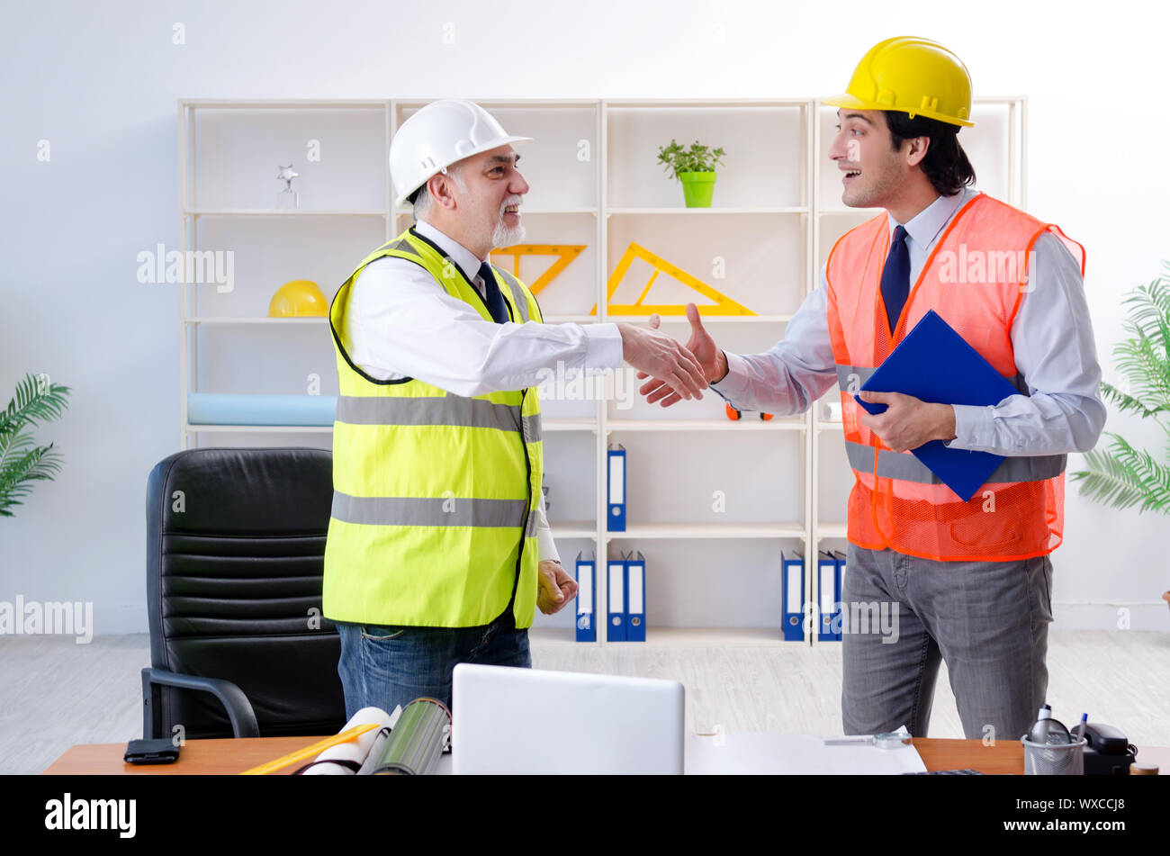 Two engineers colleagues working under project Stock Photo - Alamy
