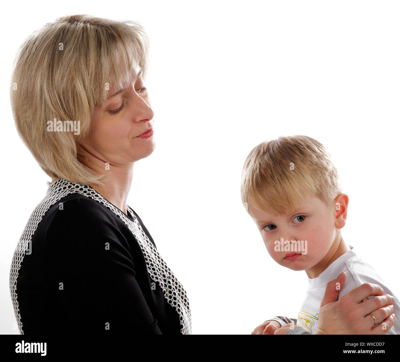 Little Boy sitting opposite his Mother and Offended Stock Photo - Alamy