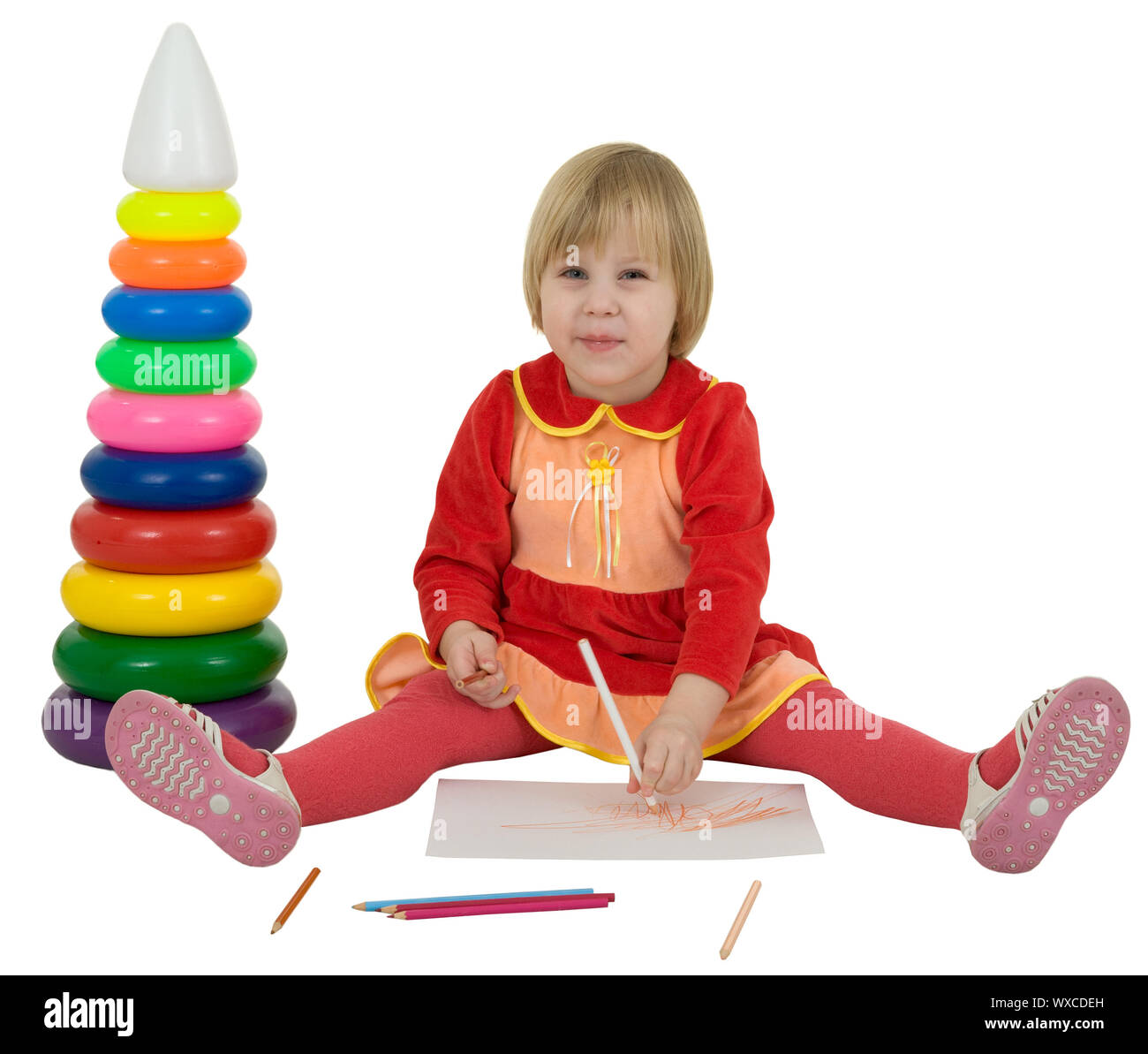 Little girl and crayons and toy plastic pyramid Stock Photo - Alamy