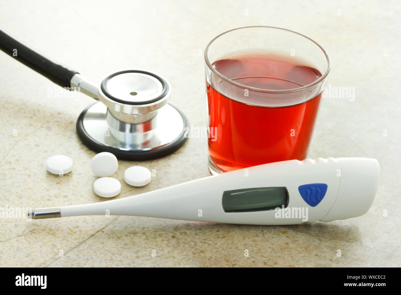 thermometer, stethoscope, cough syrup and pills Stock Photo - Alamy