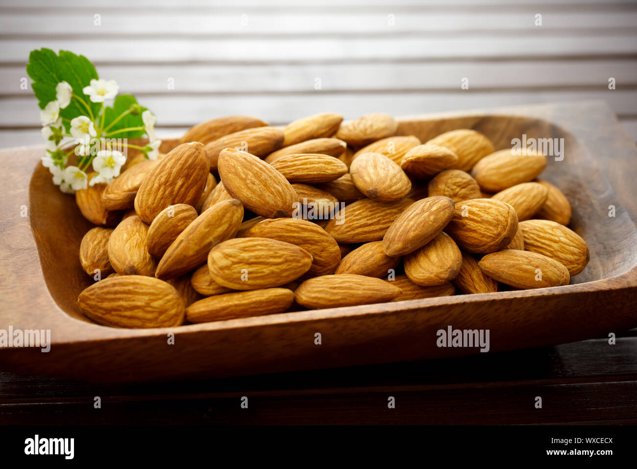 Almonds in wooden plate Stock Photo - Alamy