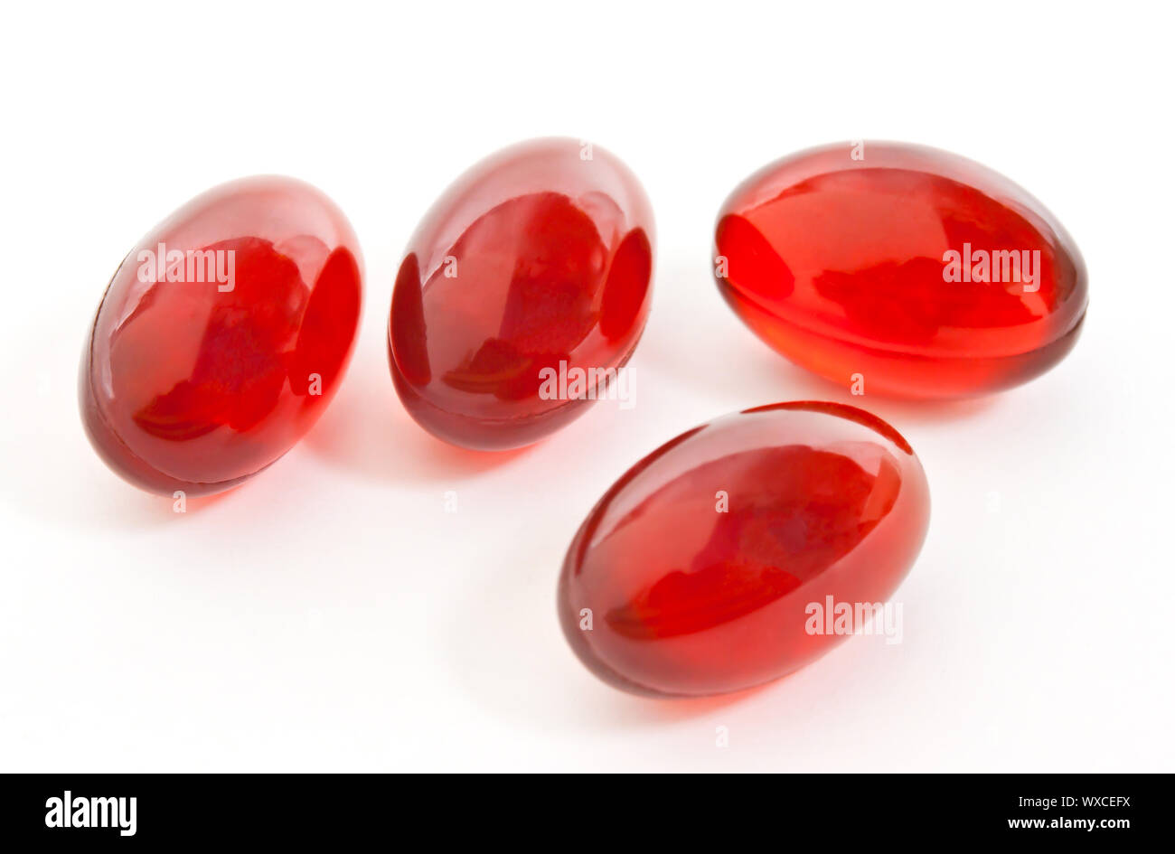 Red Gel Capsules isolated on white background Stock Photo - Alamy
