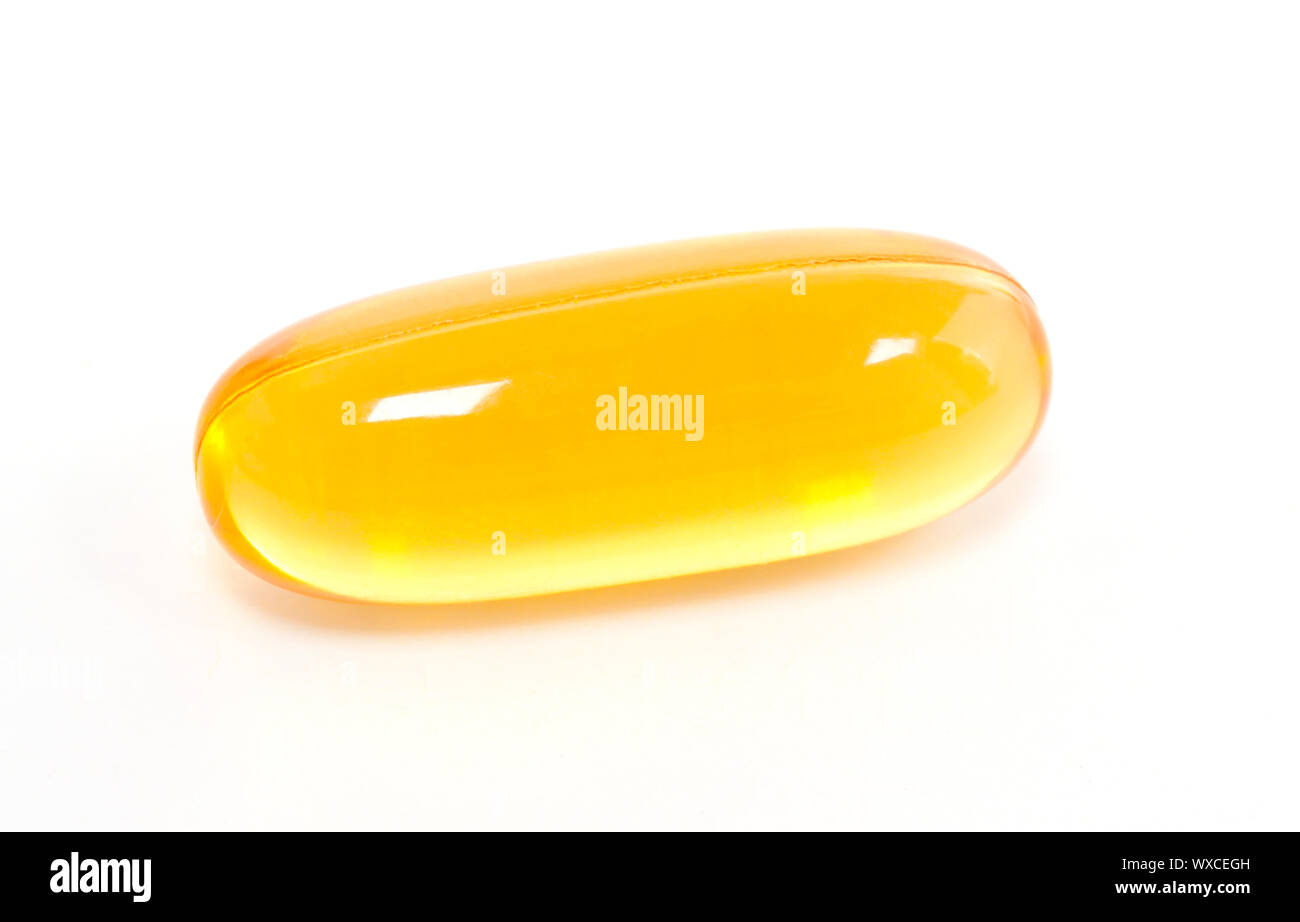 Yellow gel capsule isolated on white background Stock Photo - Alamy