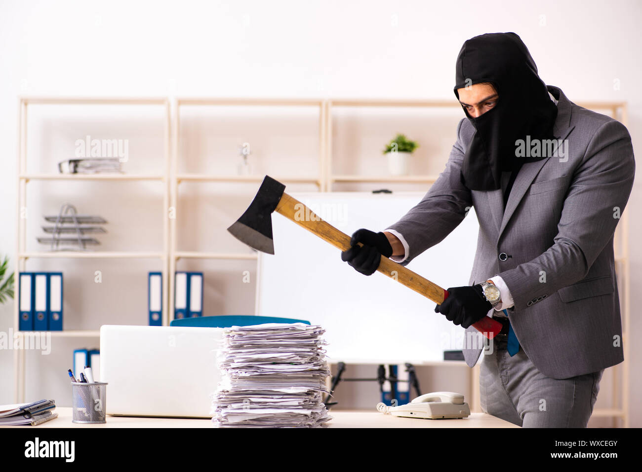 Male gangster stealing information from the office Stock Photo - Alamy