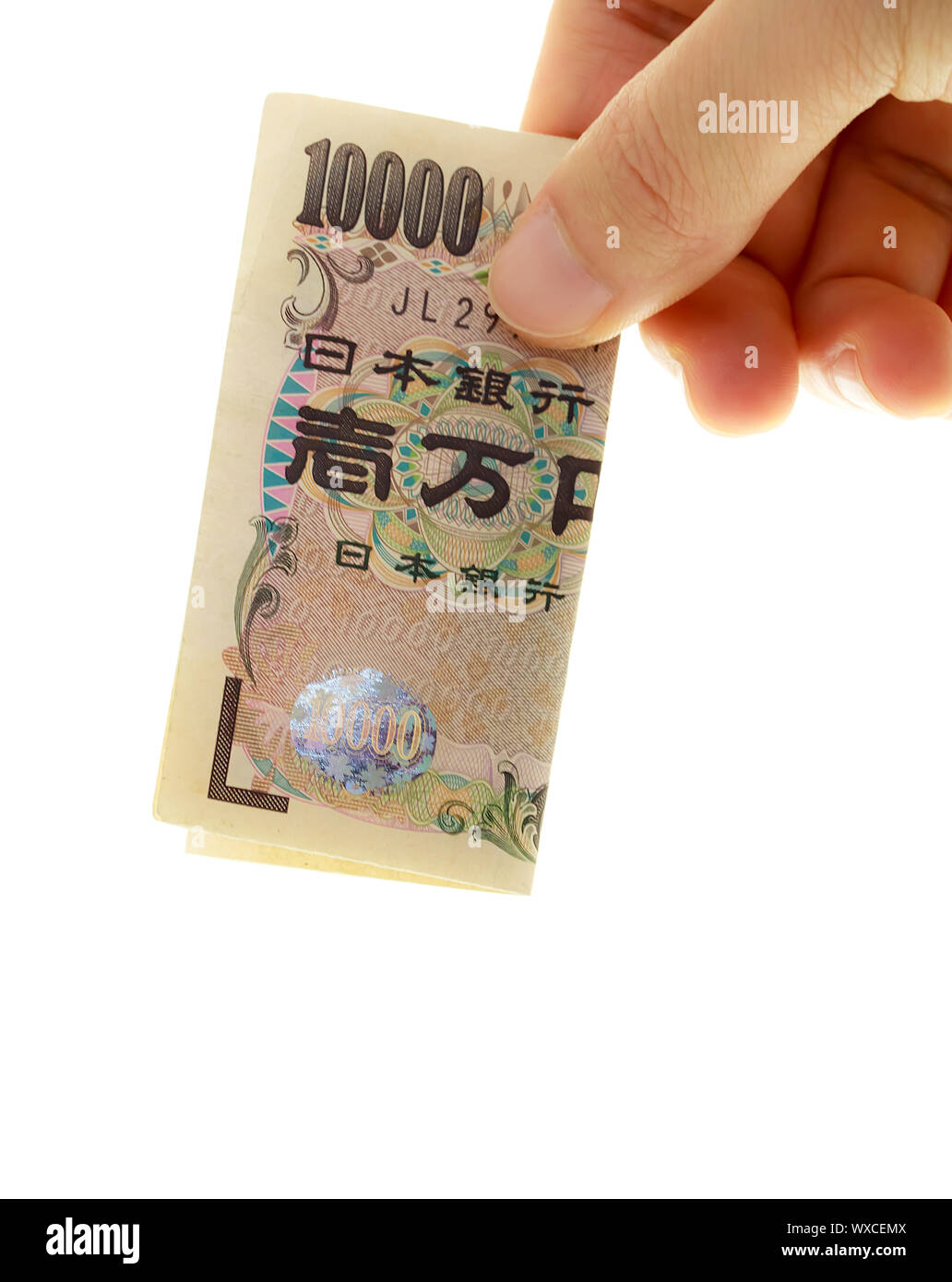 Hand holding Japanese ten thousand yen on white background Stock Photo ...