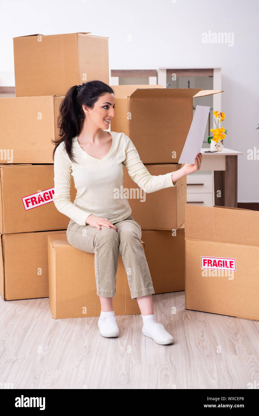 Young woman moving to new flat Stock Photo - Alamy