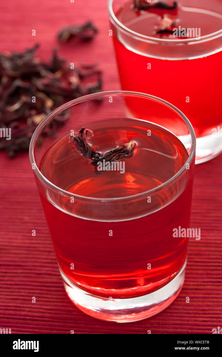 Hibiscus herbal tea in glass cup Stock Photo - Alamy