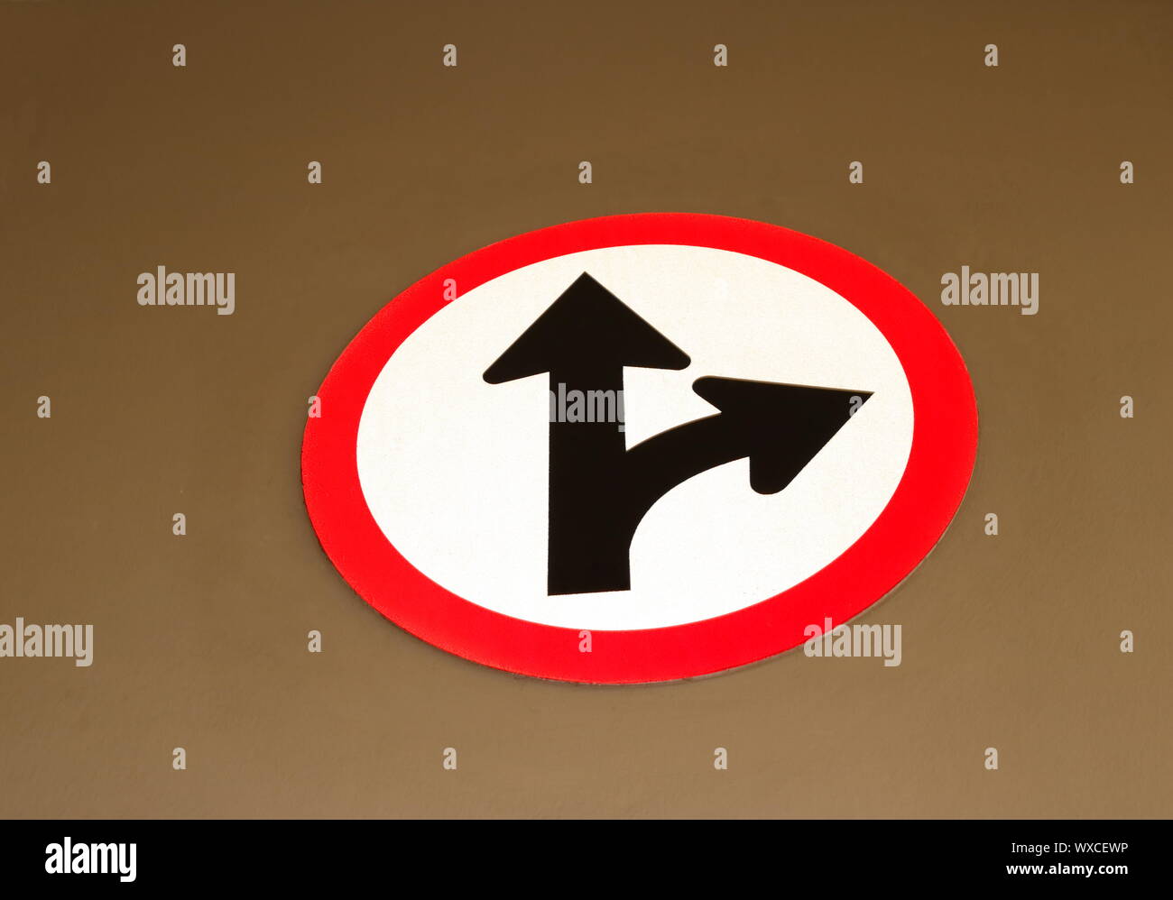 Closeup traffic sign, go straight or turn right installed on the wall ...