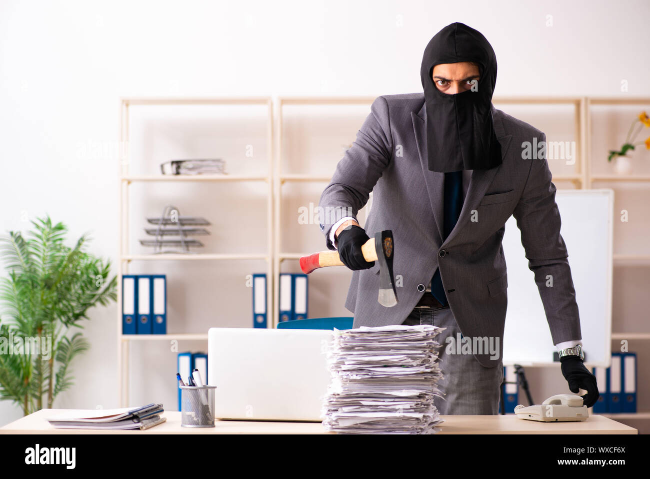 Male gangster stealing information from the office Stock Photo - Alamy