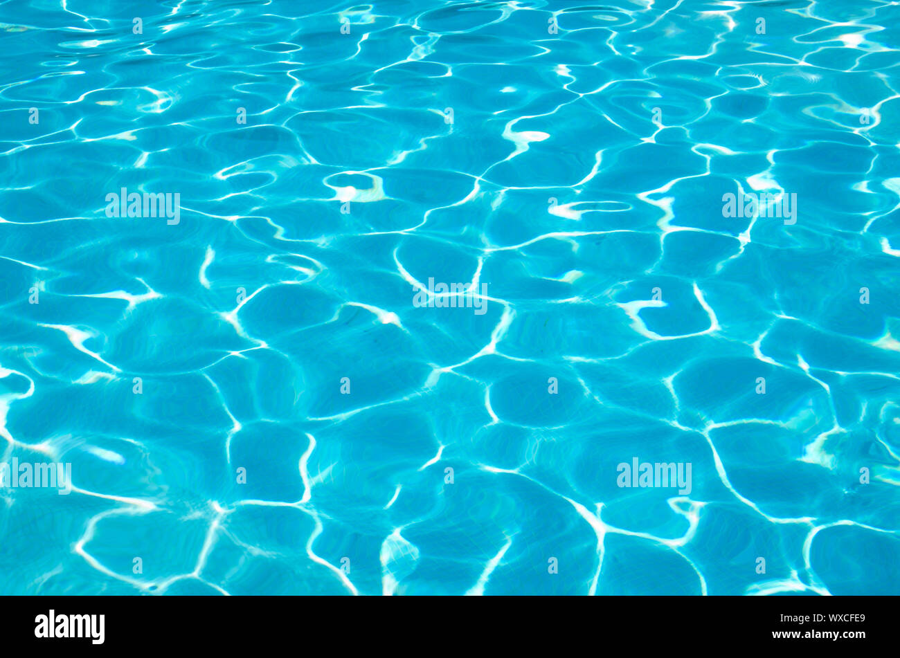 Blue pool water with sun reflections Stock Photo - Alamy