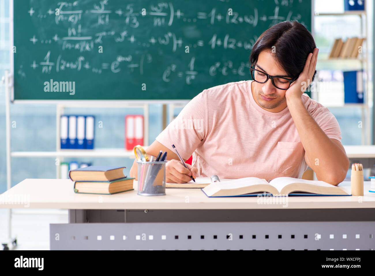 Young male student in the classroom Stock Photo - Alamy