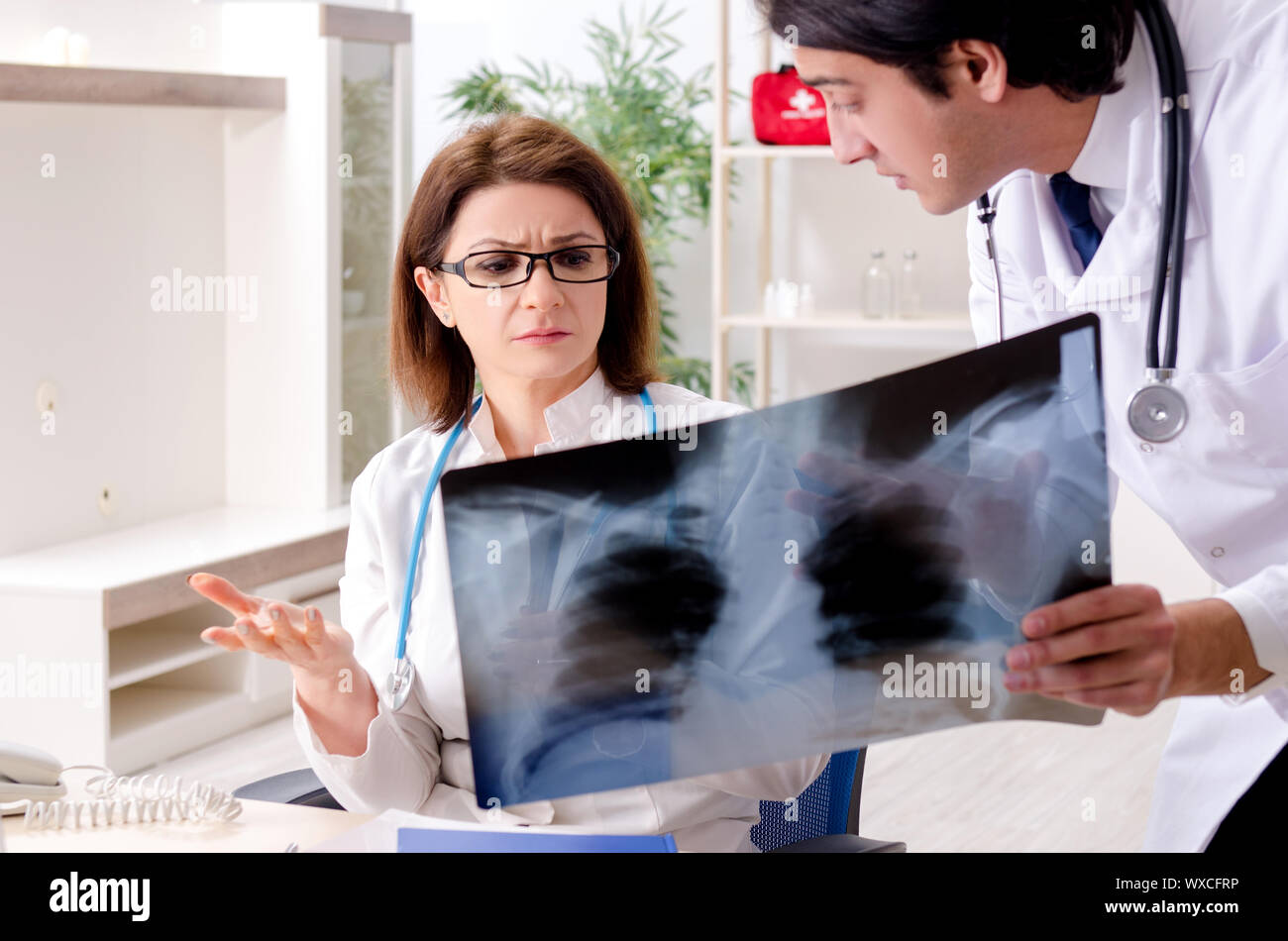 Two doctors working in the clinic Stock Photo - Alamy