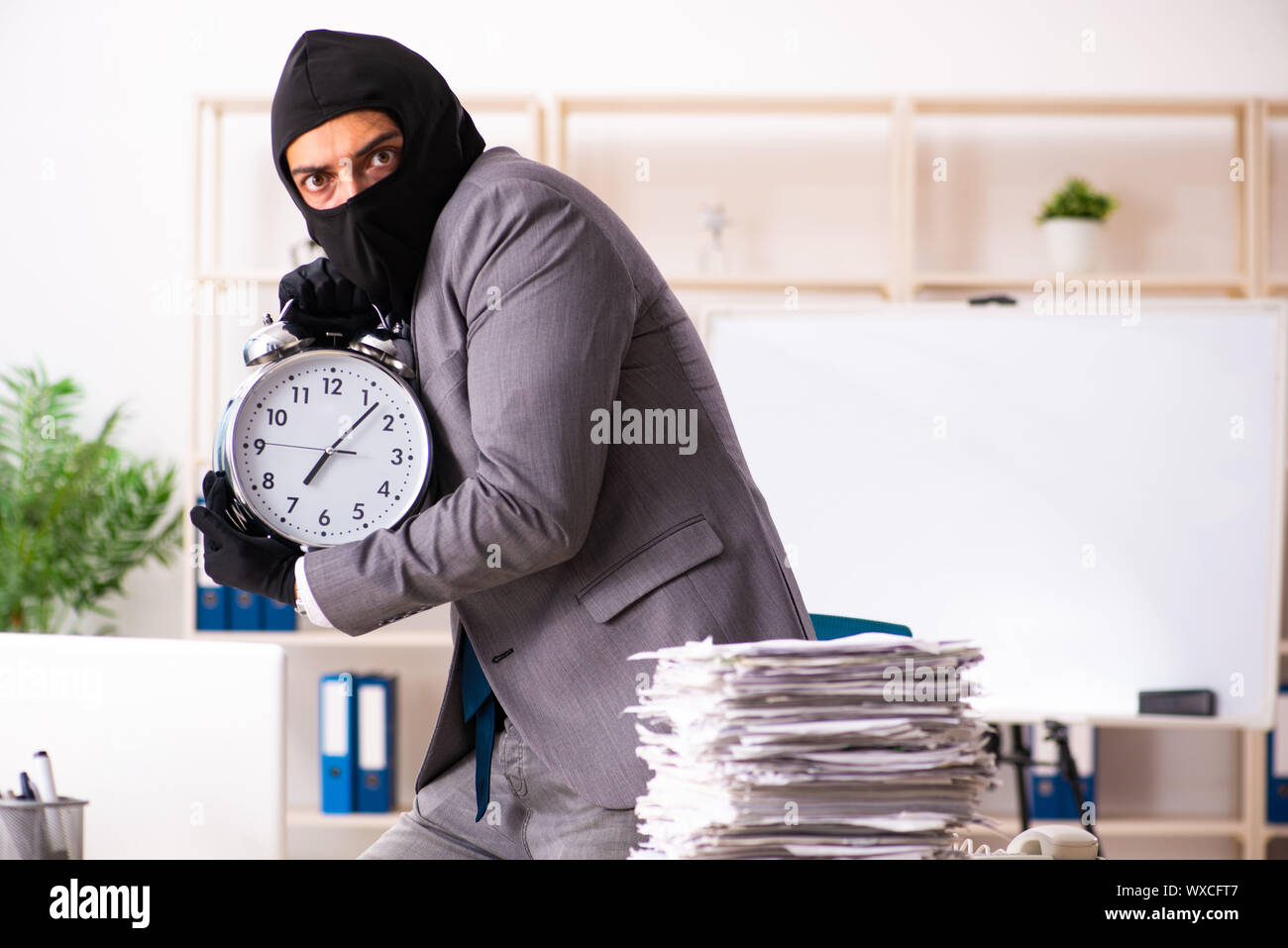 Male gangster stealing information from the office Stock Photo - Alamy