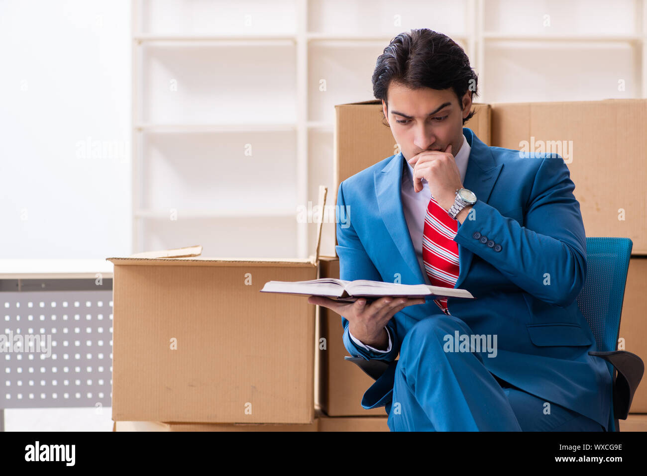 Young handsome businessman moving to new workplace Stock Photo - Alamy