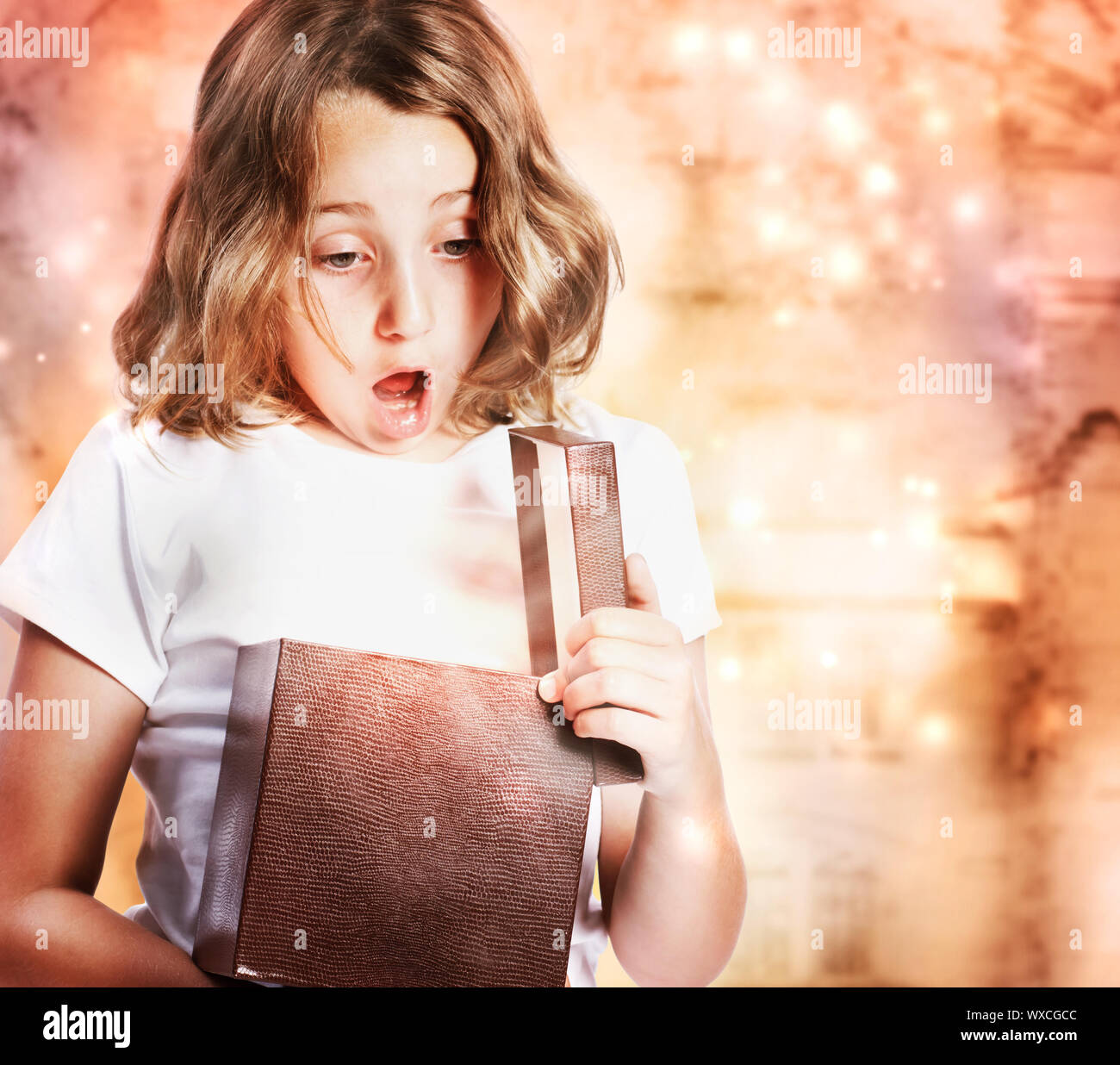 Happy Little Girl Opening a Present Stock Photo - Alamy