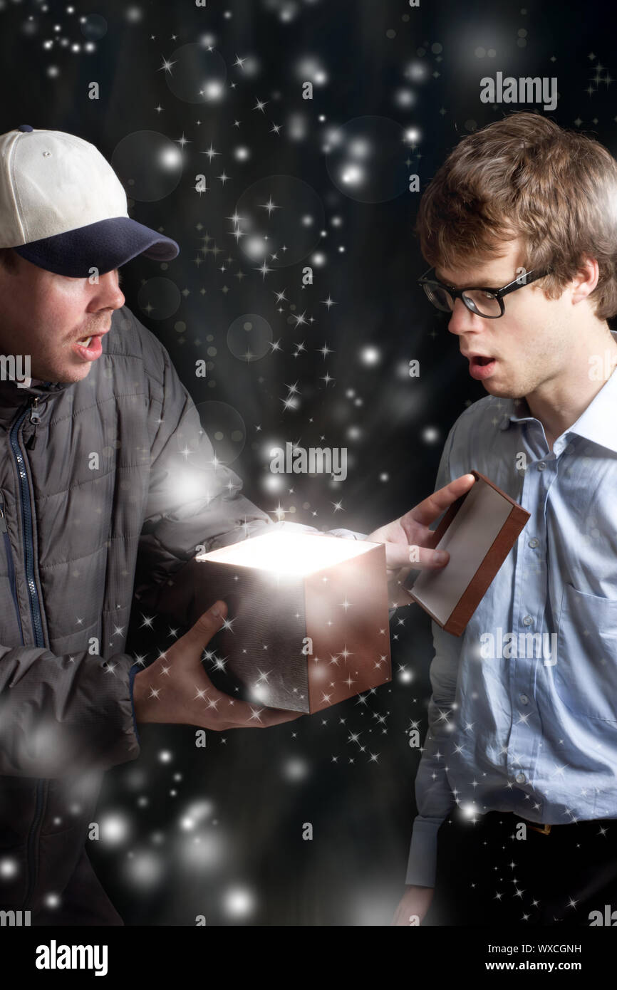 Two Man Opening a Magic Gift Box Stock Photo - Alamy
