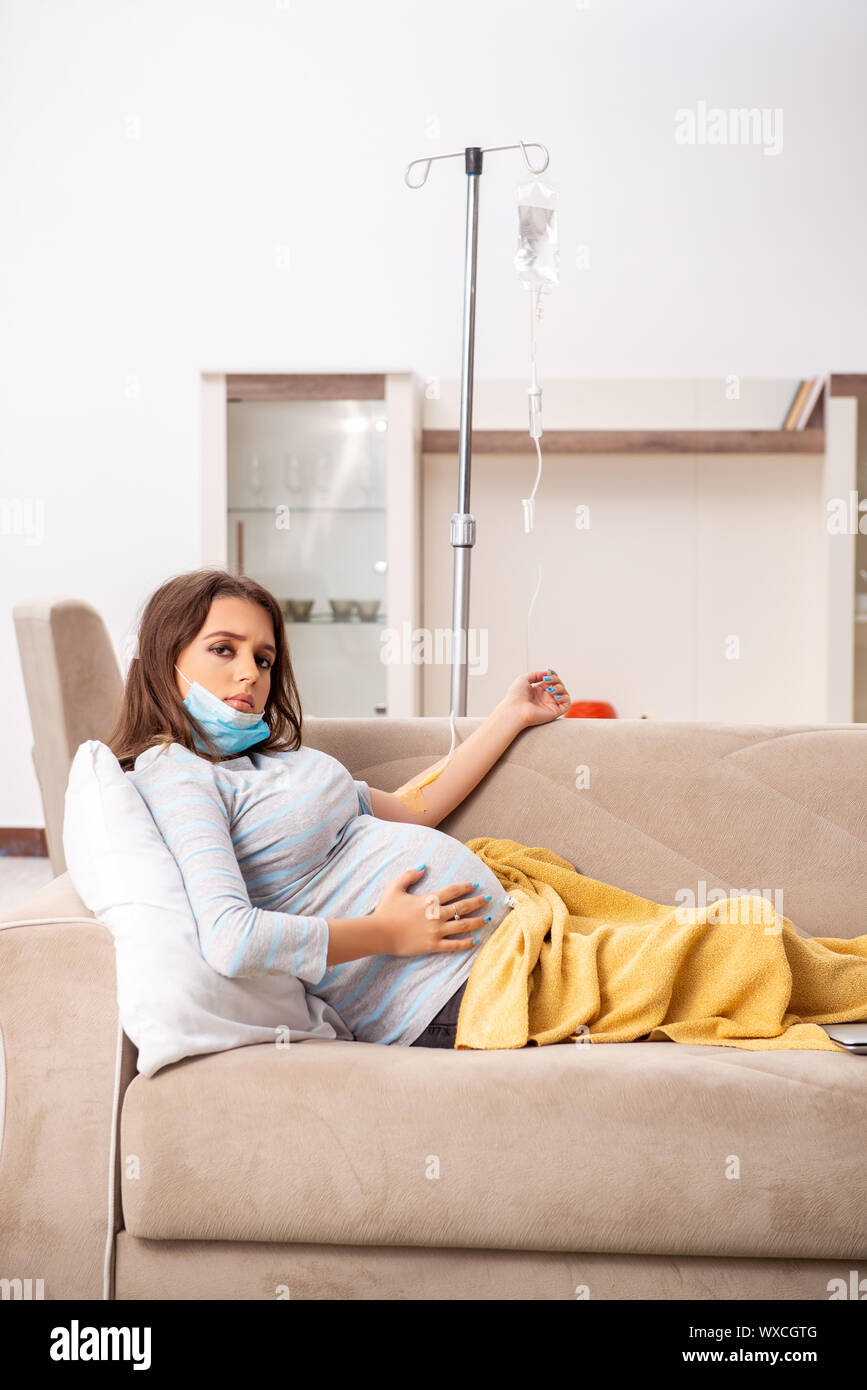 Sick pregnant woman suffering at home Stock Photo - Alamy