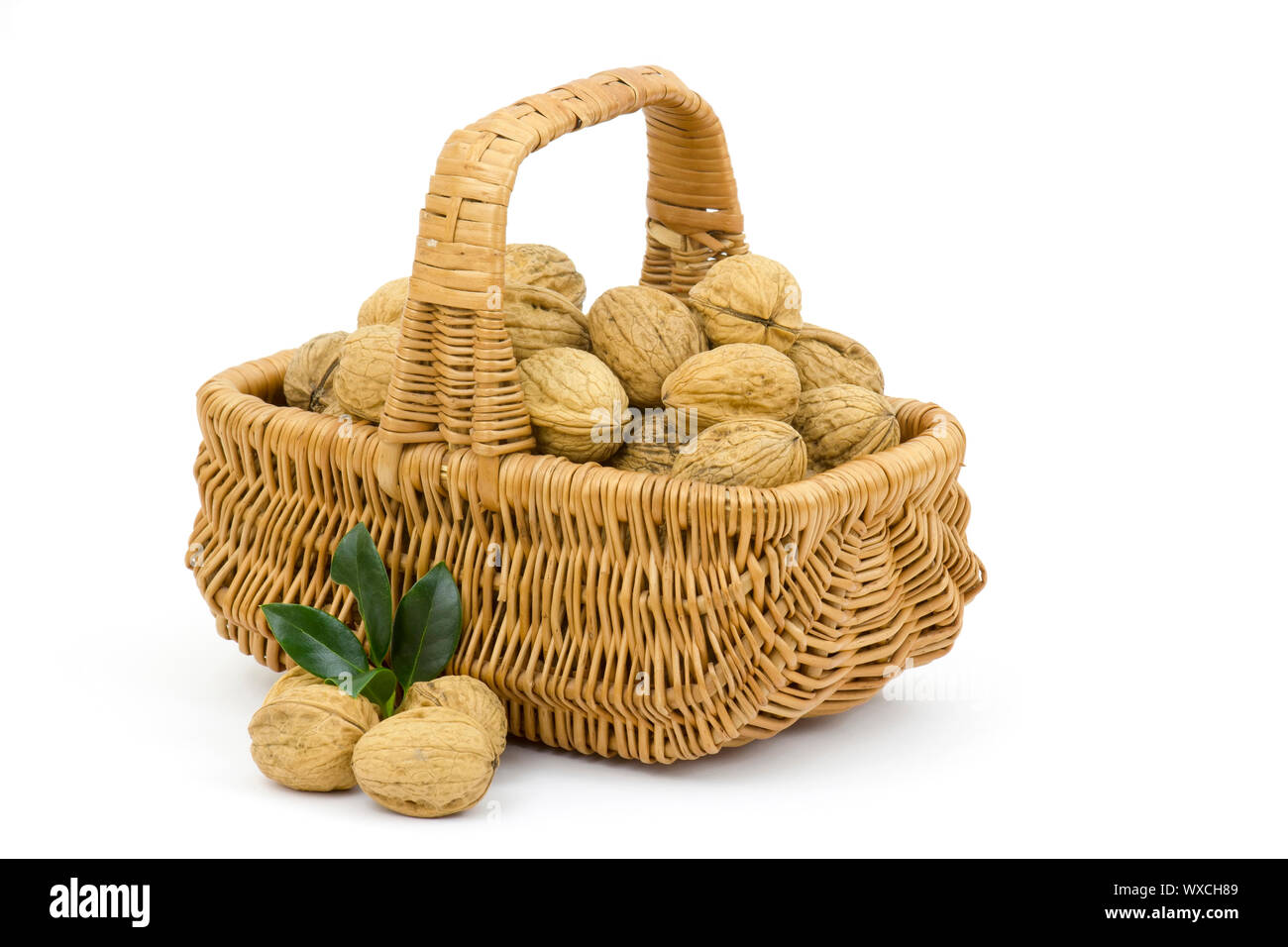 basket full of whole walnuts on white background Stock Photo - Alamy