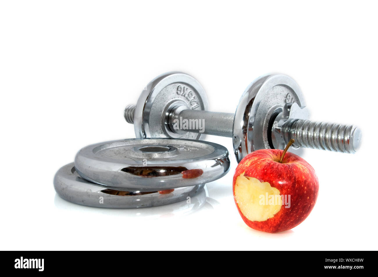 Heavy dumbbells and apple to come in shape Stock Photo - Alamy