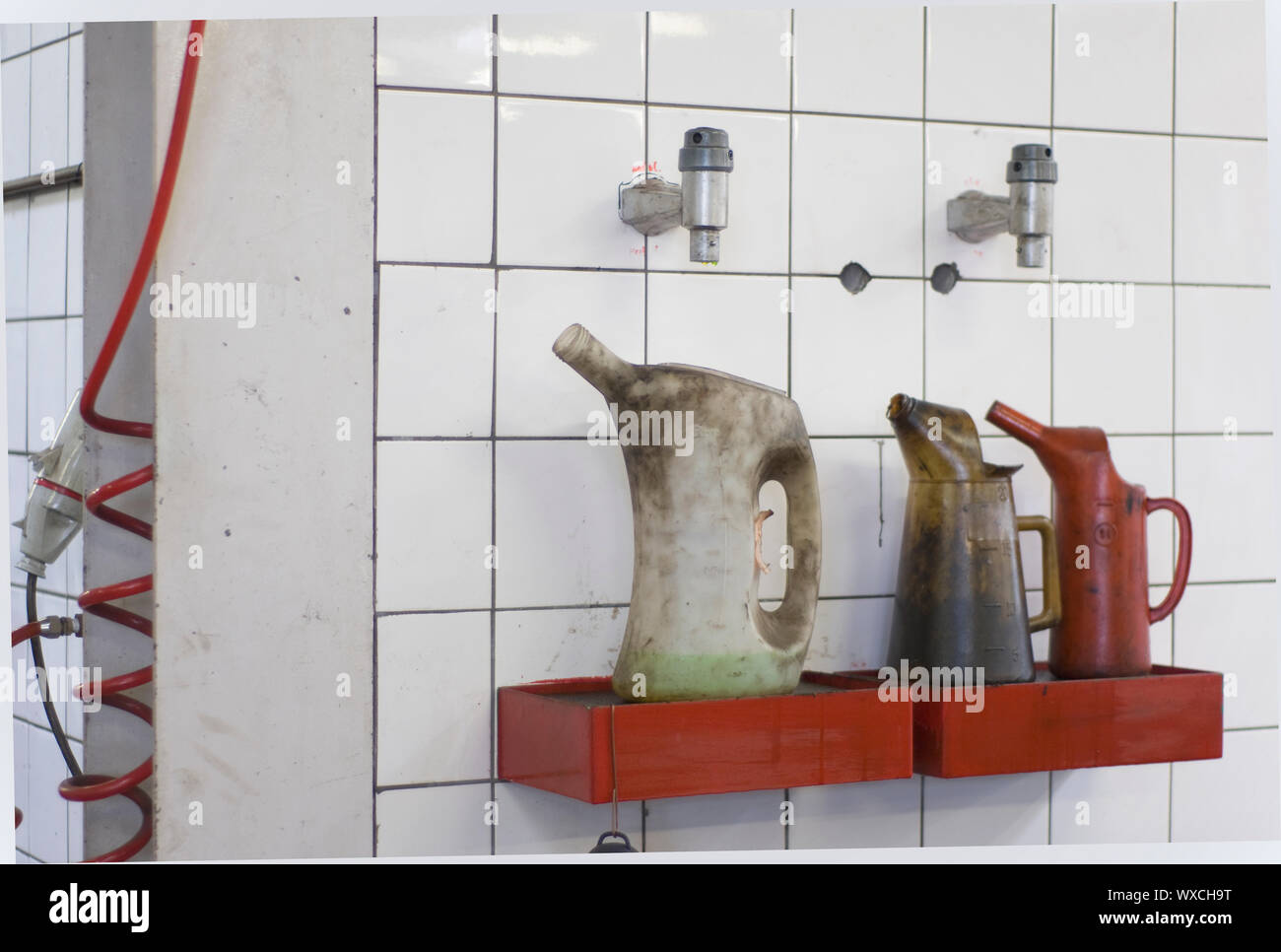 bottles with oil in the garage Stock Photo - Alamy
