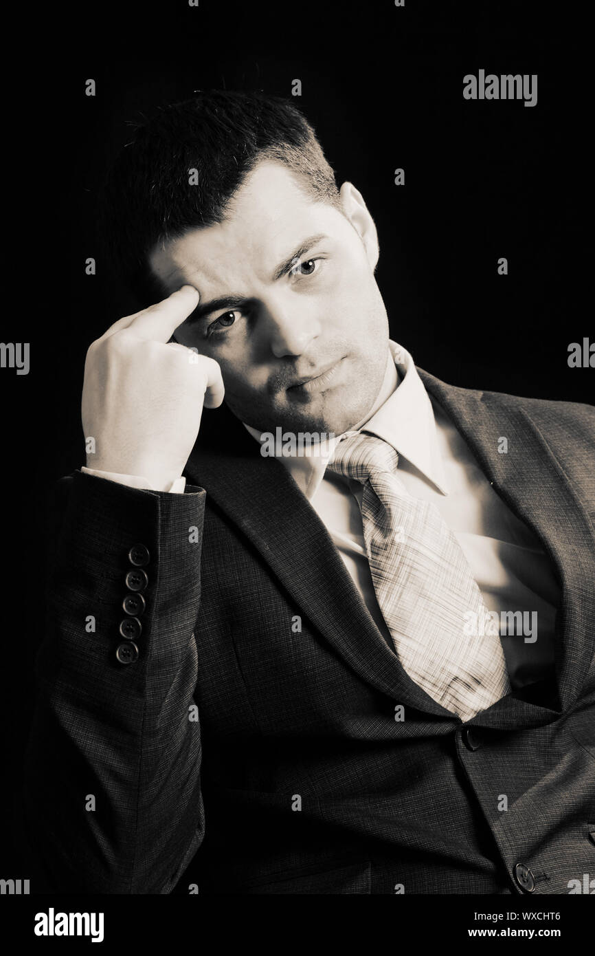 Young man wearing suit with tie sitting waiting Stock Photo - Alamy