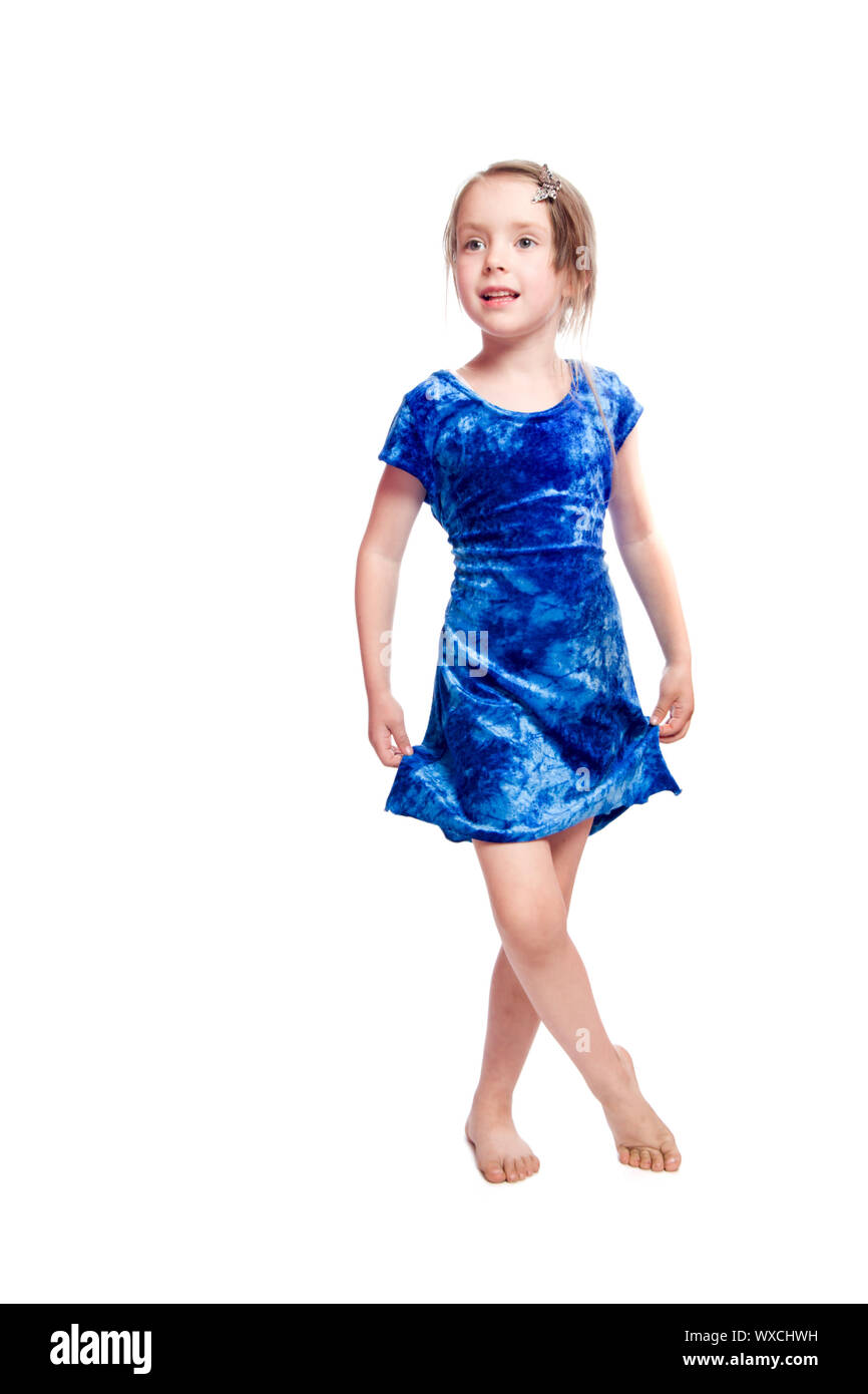 Dancing little girl wearing blue dress isolated on white Stock Photo ...