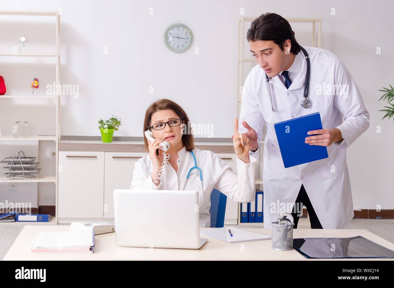 Two doctors working in the clinic Stock Photo - Alamy