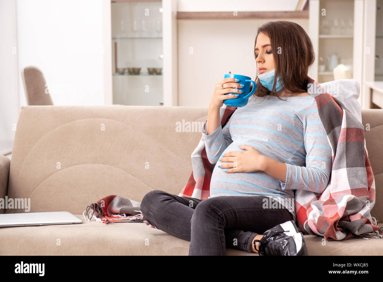 Sick pregnant woman suffering at home Stock Photo - Alamy