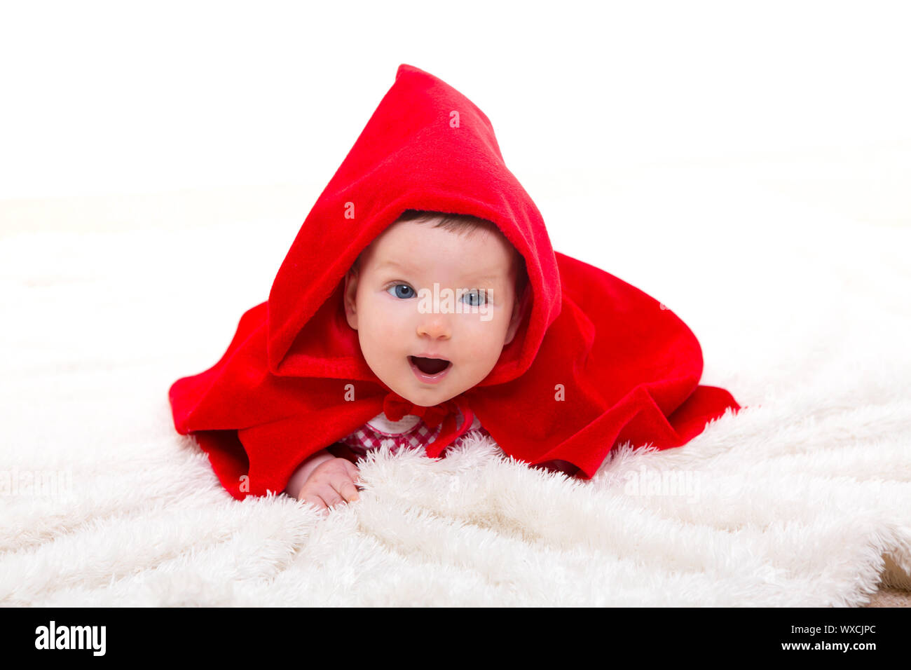 Baby Little Red Riding Hood on white fur with funny expression Stock ...