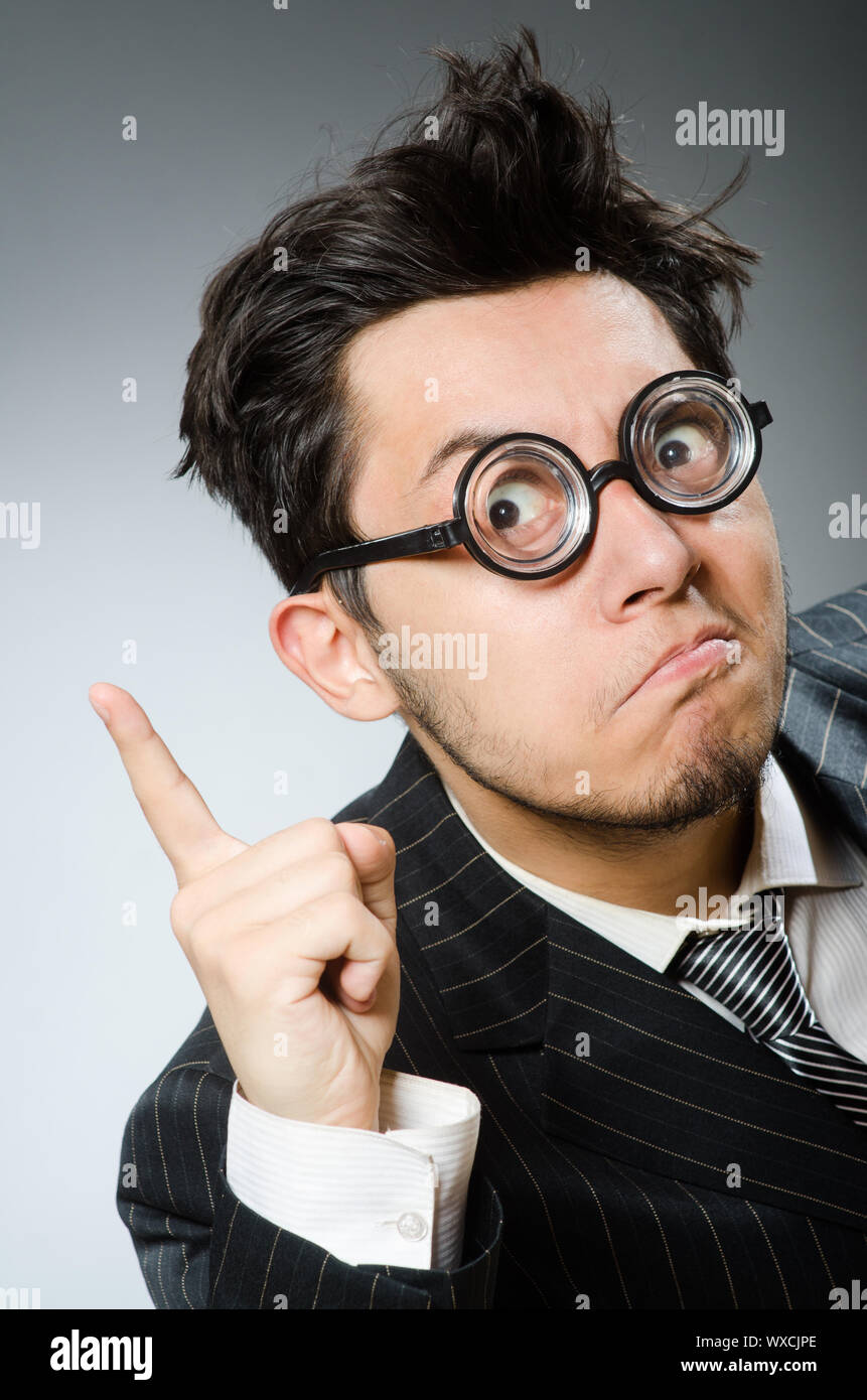 Funny nerd businessman in dark studio Stock Photo - Alamy