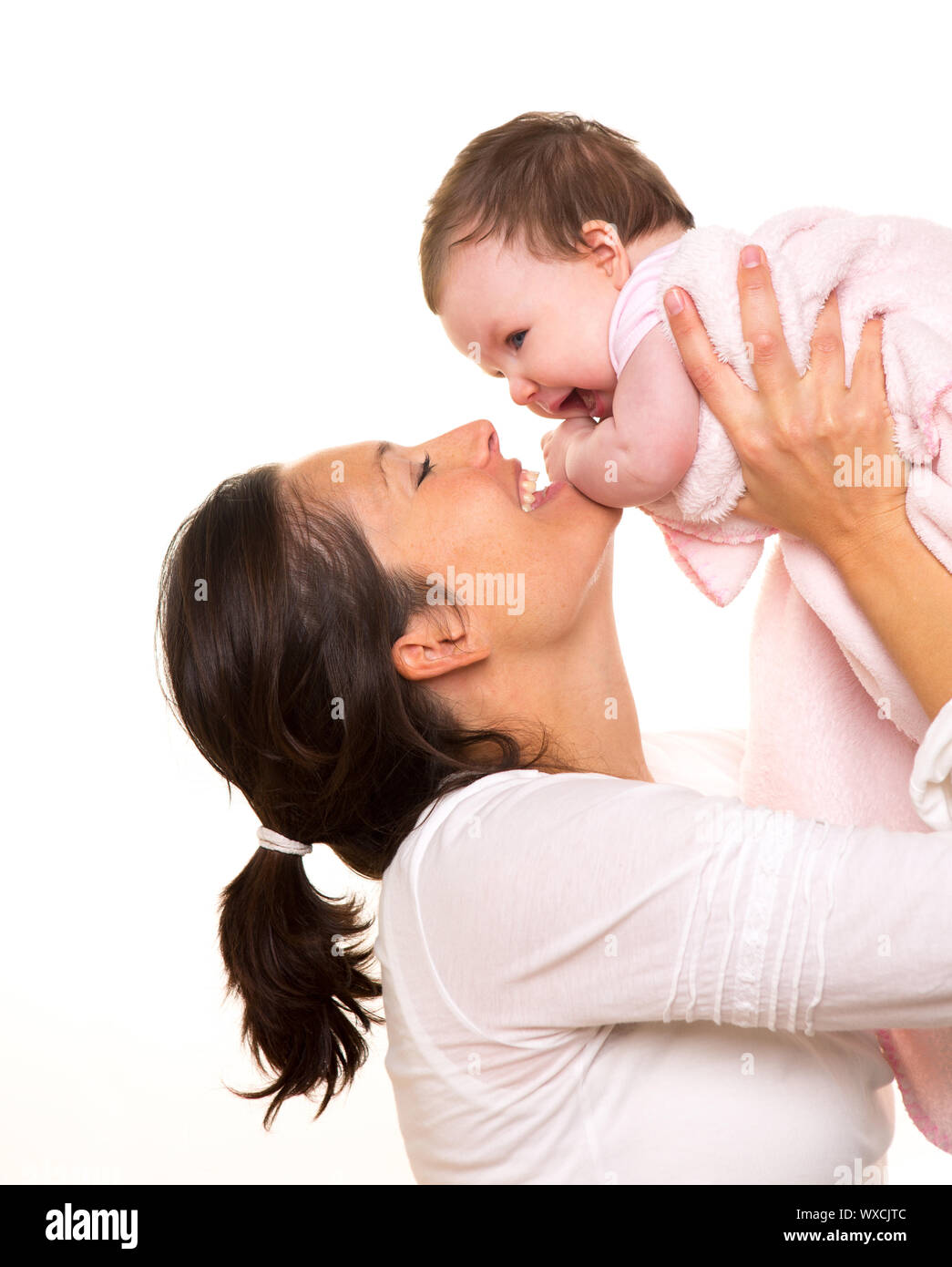 Baby girl hug in mother arms playing happy on white background Stock ...