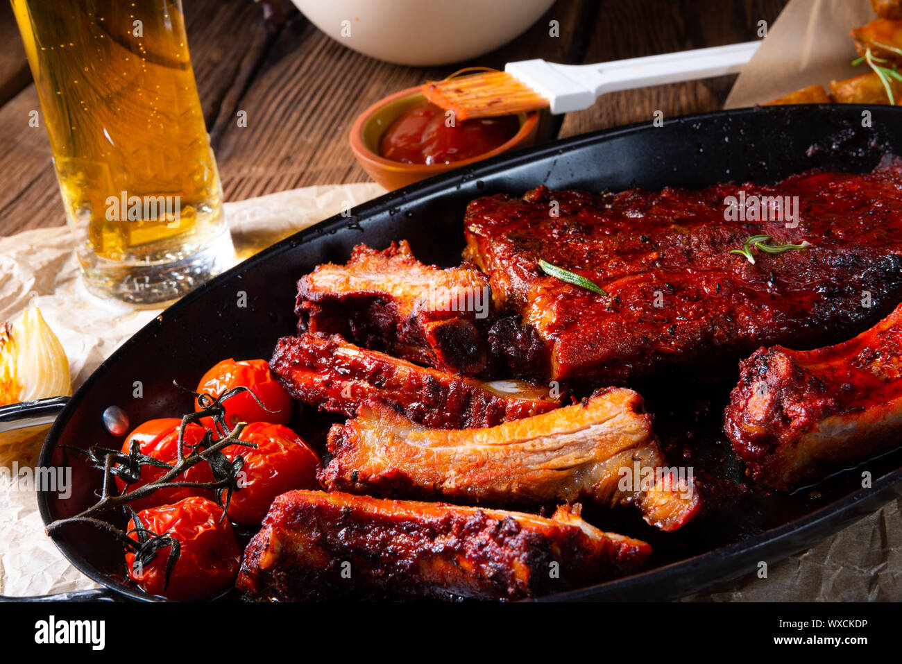 Grilled ribs in spicy marinade with salad and vegetables Stock Photo ...