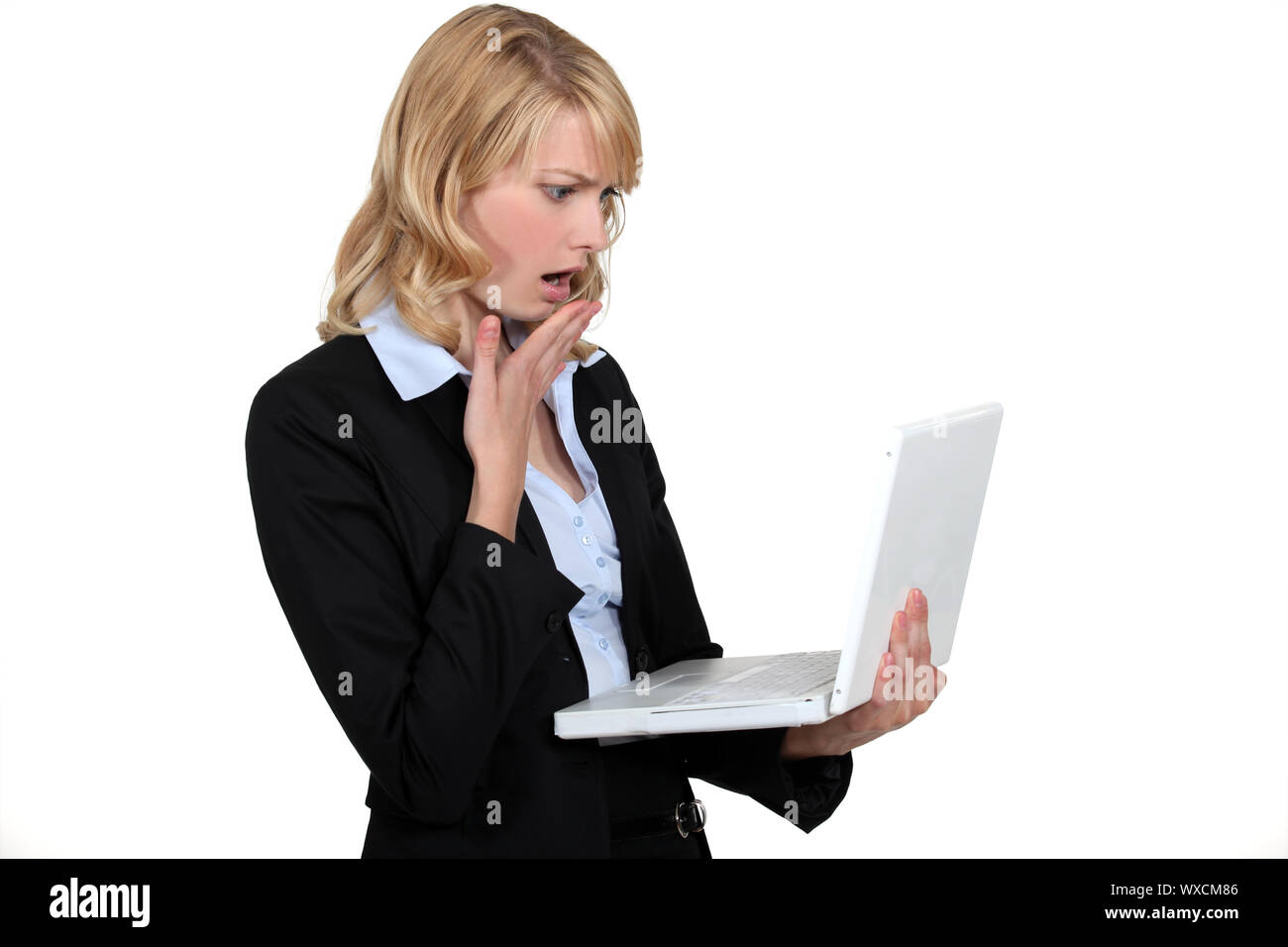 Woman shocked in front of computer Stock Photo - Alamy
