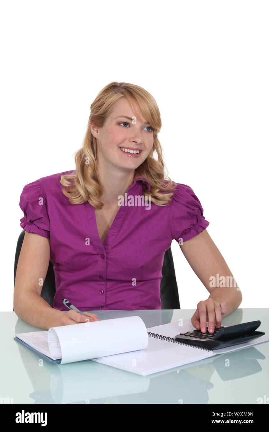 cute secretary all smiles using calculator Stock Photo - Alamy