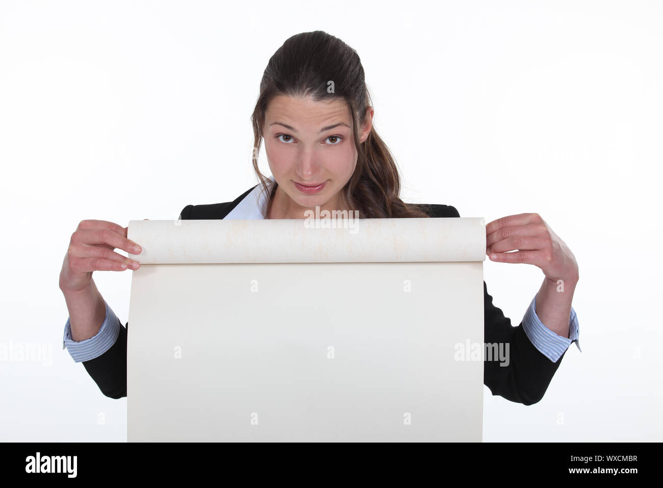 Woman unrolling a roll of paper Stock Photo - Alamy